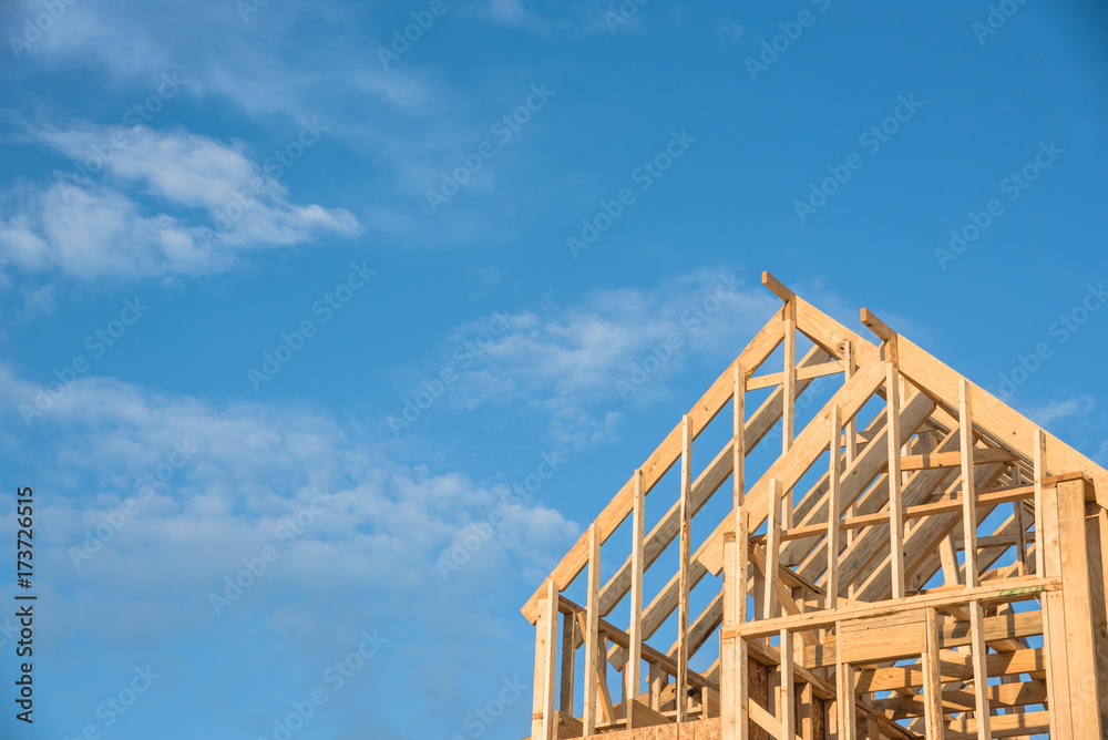 Close-up of gables roof on stick built home under construction and blue ...