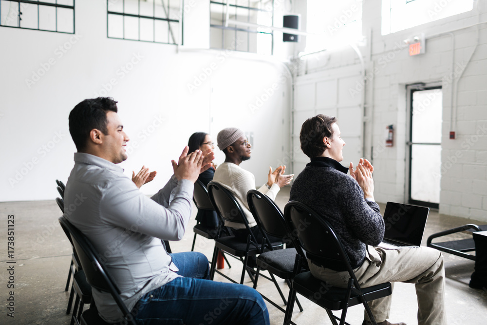 Audience clapping in an auditorium Stock Photo | Adobe Stock