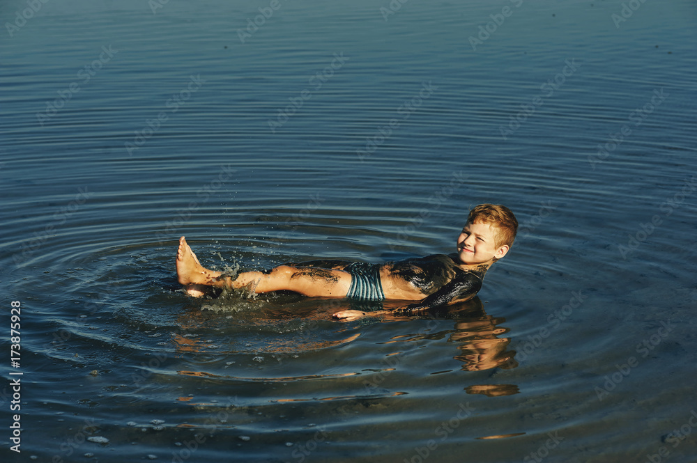 children take mud baths at the resort and having fun with mud ...