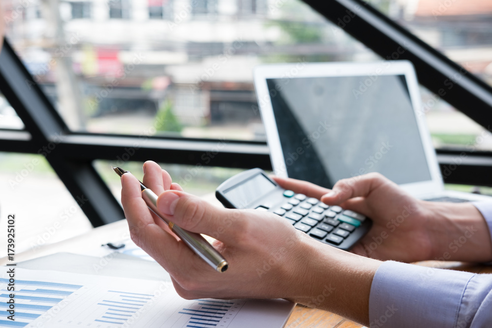 accountant counting with calculator at office. businessman analyze ...