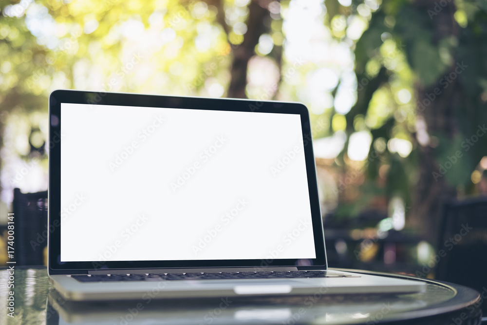 Mockup image of laptop with blank white screen on glass table at ...