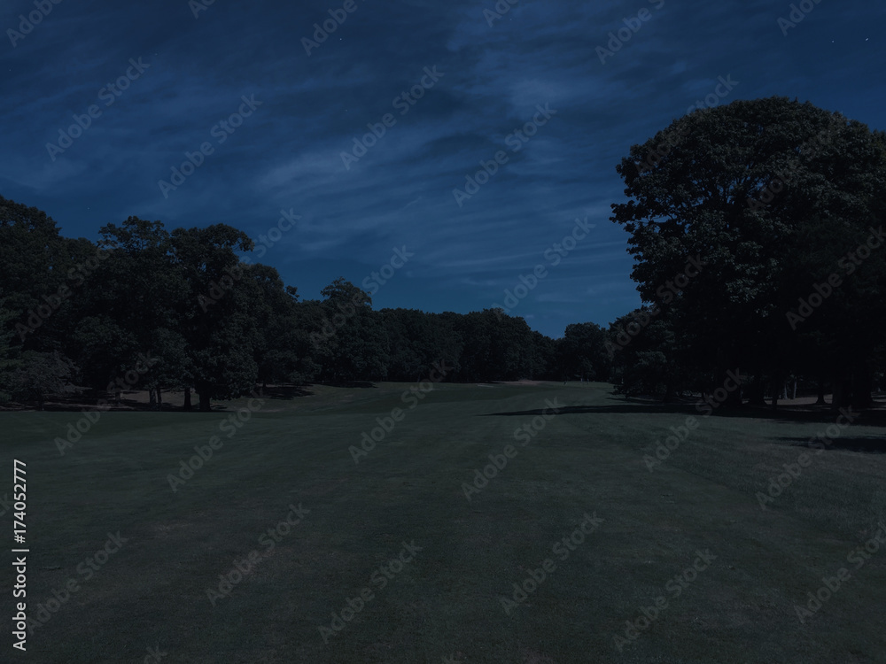 Long view down the fairway of a golf course hole on a beautiful summer ...