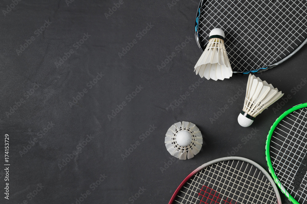 Shuttlecocks and badminton racket on black background. Stock Photo ...