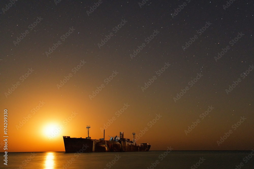 The wrecked ship under starry night with moonrise. long expose Stock ...
