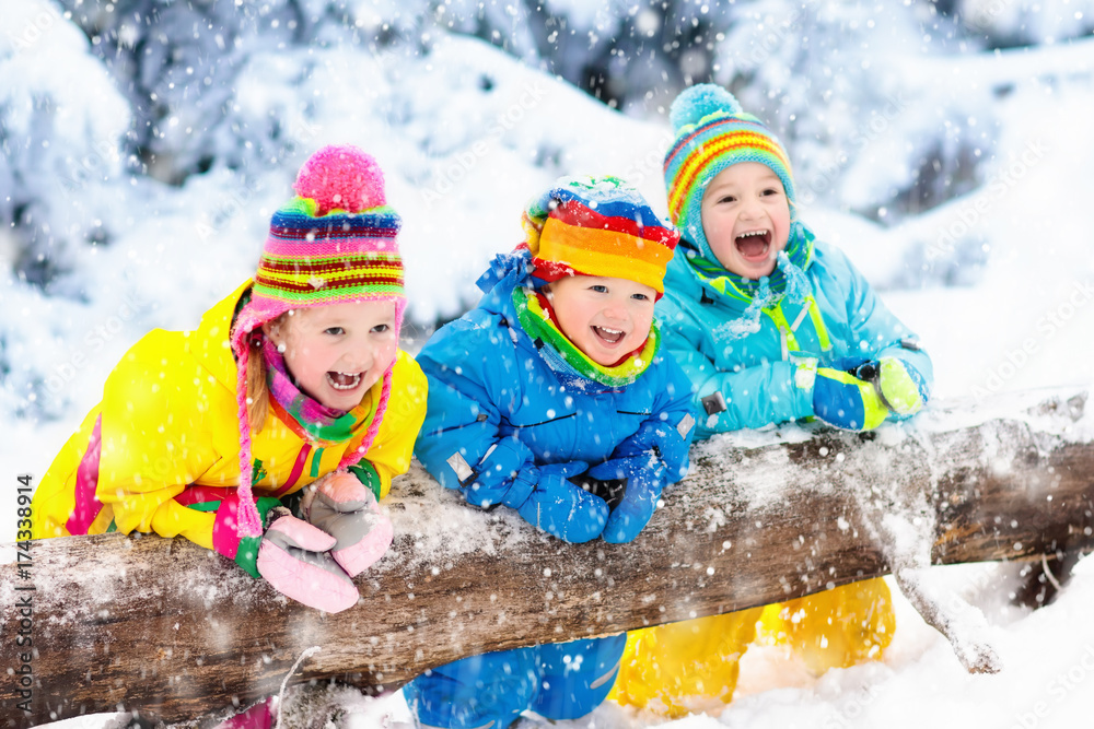 Kids playing in snow. Children play outdoors in winter snowfall. Stock ...
