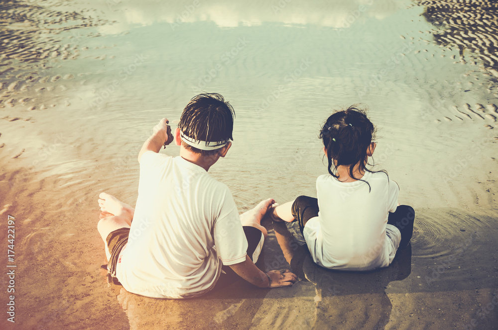Asian children digging in the sand. Concept of connecting children with ...