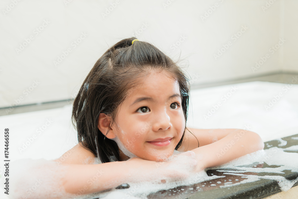pretty smiling female children bathing in bathtub Stock Photo | Adobe Stock