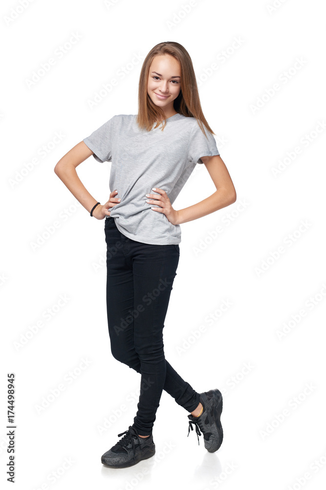 Teen Girl In Full Length Posing With Hands On Hips Smiling At Camera