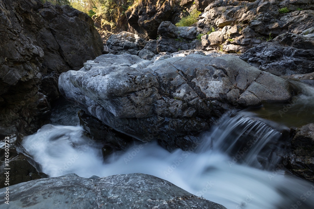Water spring running down the smooth rocks in a beautiful canyon. Taken ...