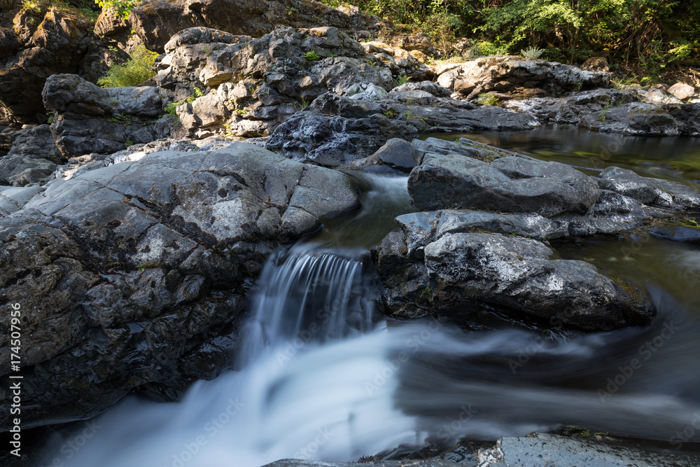 Water spring running down the smooth rocks in a beautiful canyon. Taken ...