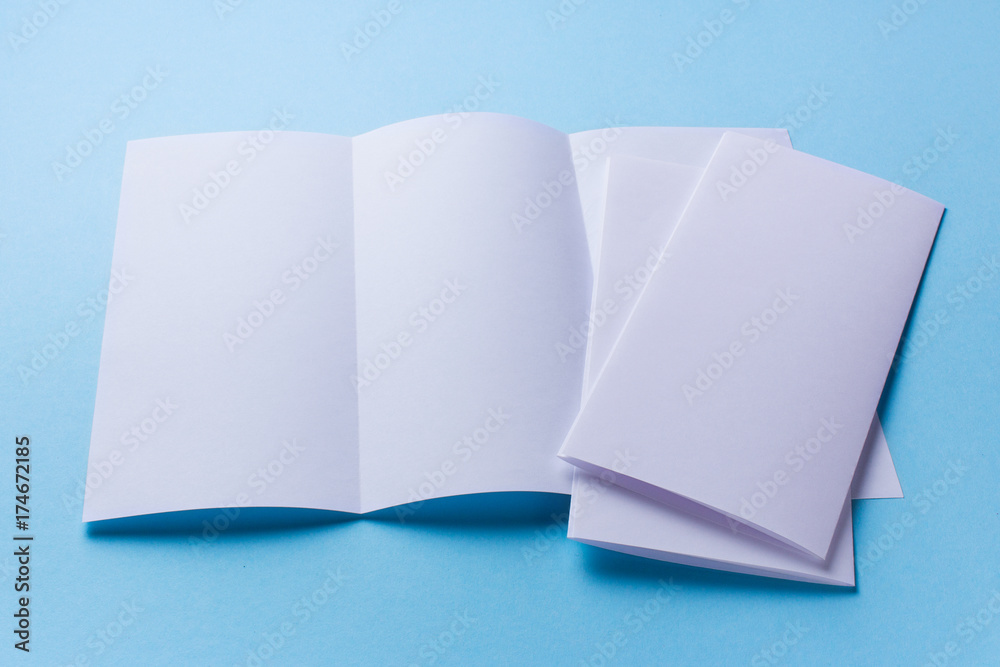 Leaflet blank tri-fold white paper brochure mockup on blue background ...