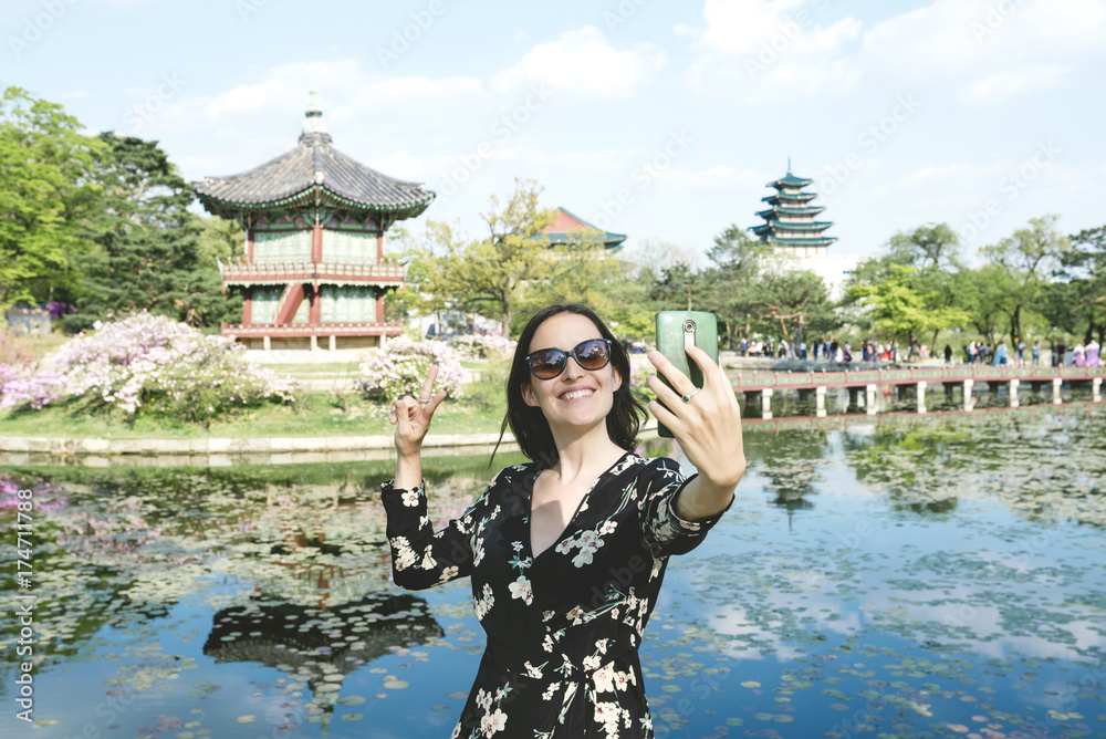 South Korea, Seoul, Woman taking a selfie with smartphone at ...