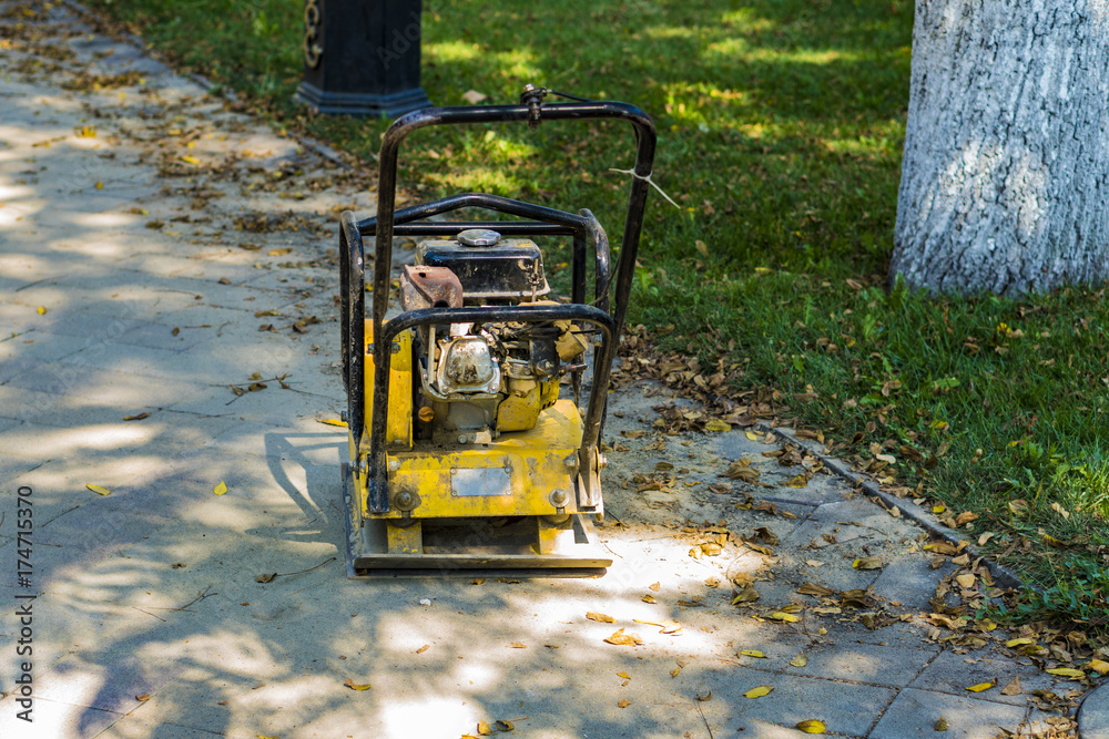 Vibro stacker of paving slab on the path in the park. Stock Photo ...