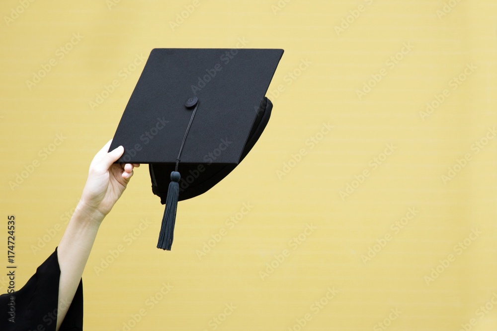 close up show hand hold hat in background yellow. Shot of graduation ...