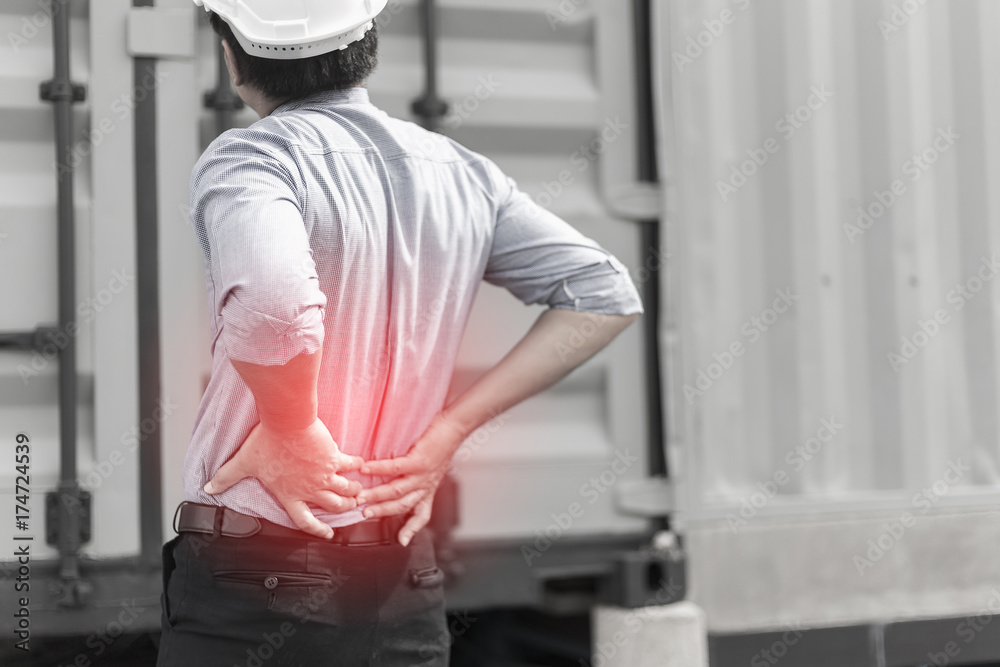 Engineer with back pain on construction site background,Highlights of ...