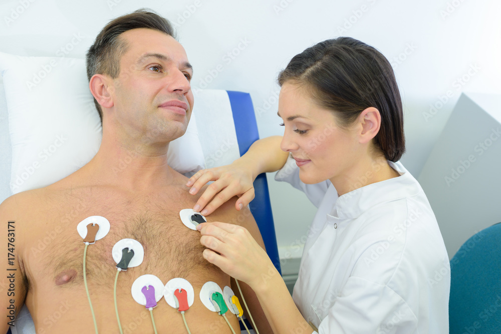 man to perform an electrocardiogram Stock Photo | Adobe Stock