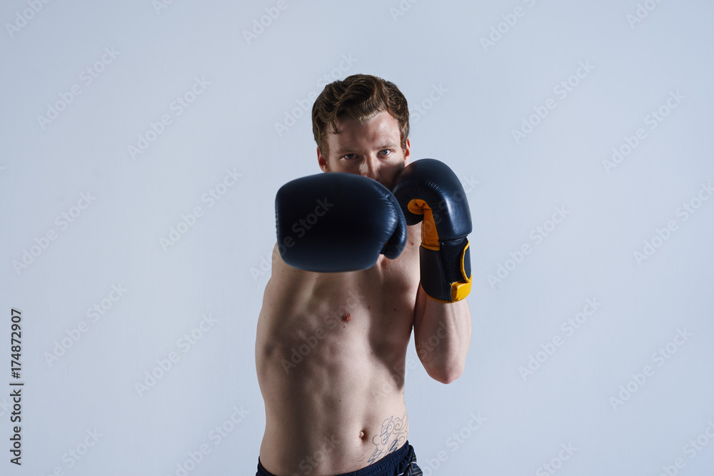 Professional sportsman with bare chest training in gym, reaching out ...