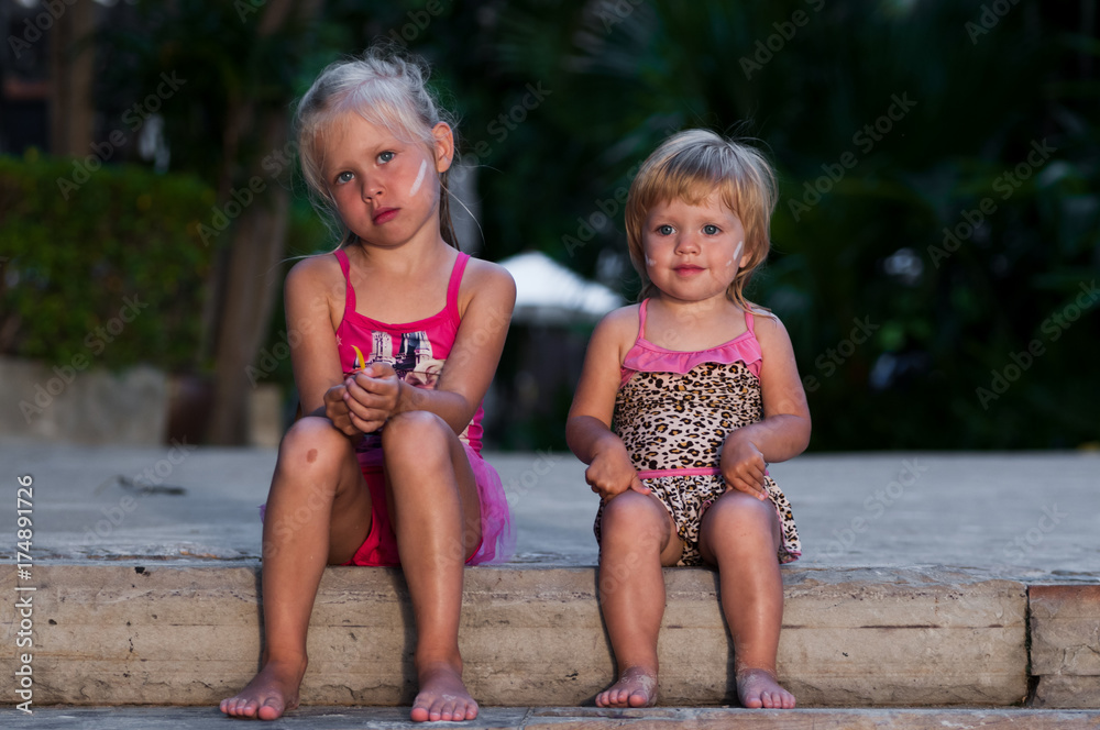 two little blonde girls in swimsuits Stock Photo | Adobe Stock