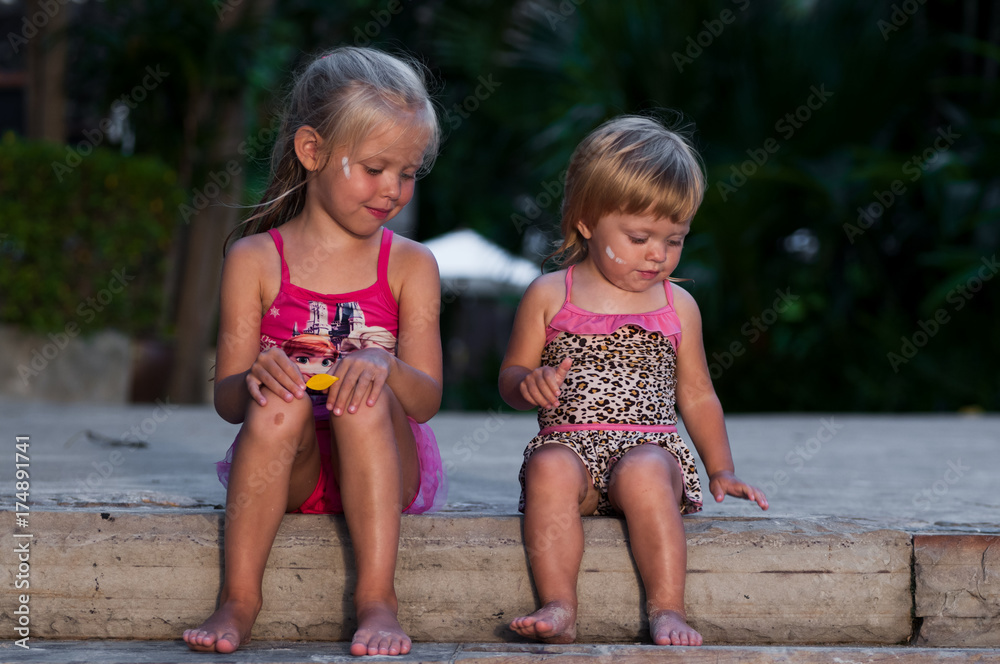 two little blonde girls in swimsuits Stock Photo | Adobe Stock