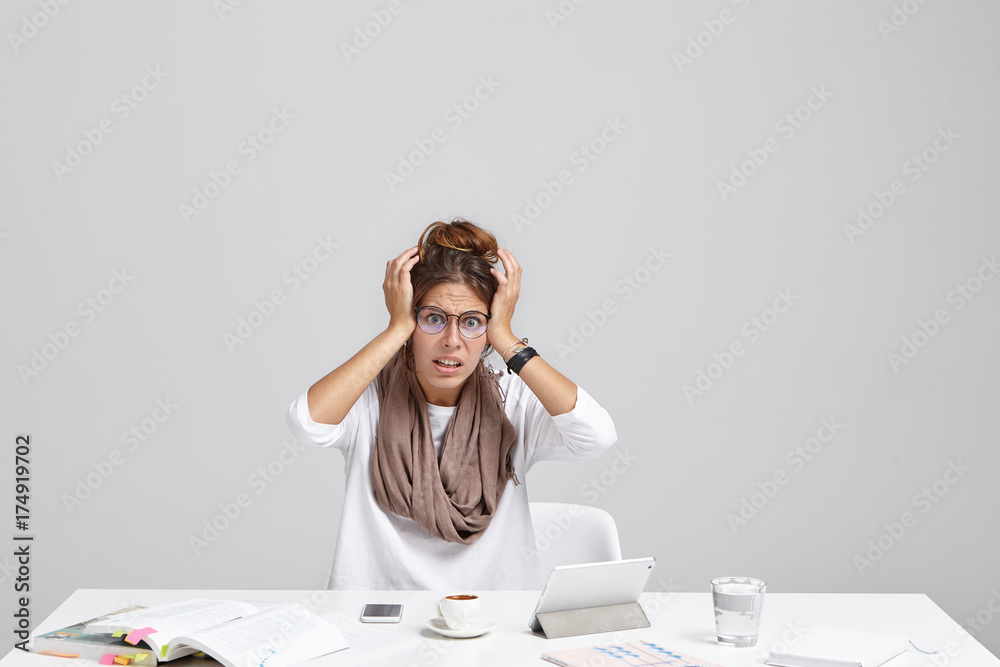 Attractive casually dressed young female secretary in stylish eyewear ...