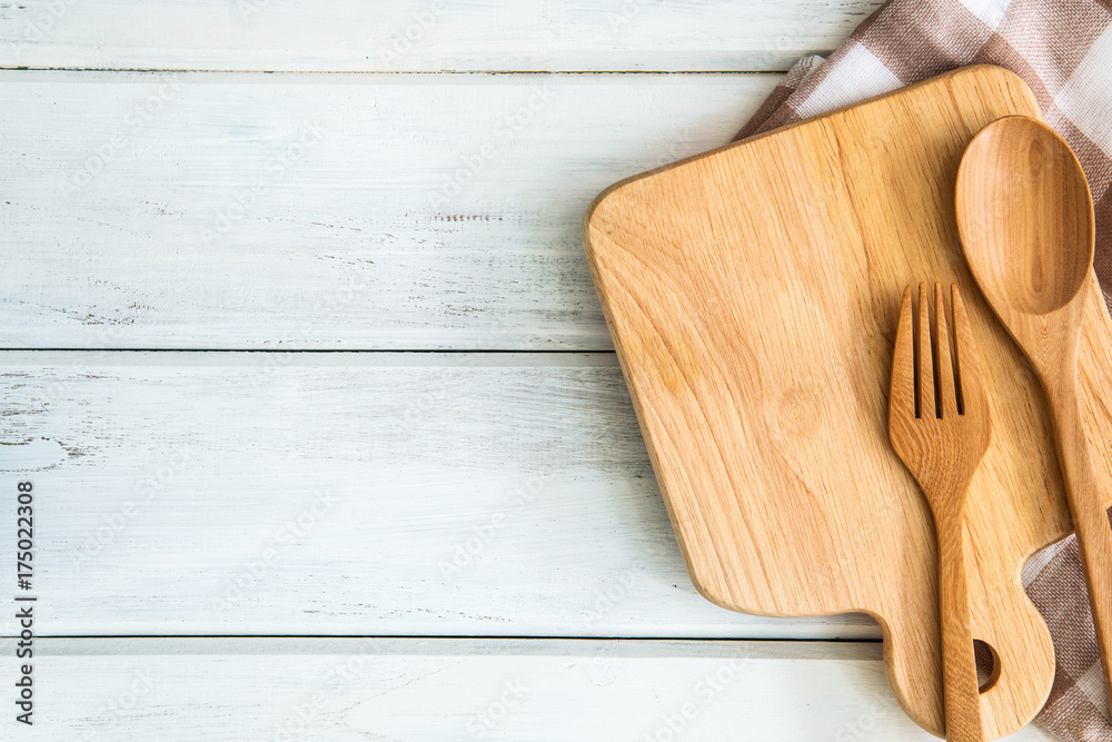 chopping board with wooden fork and spoon on white table , recipes food ...