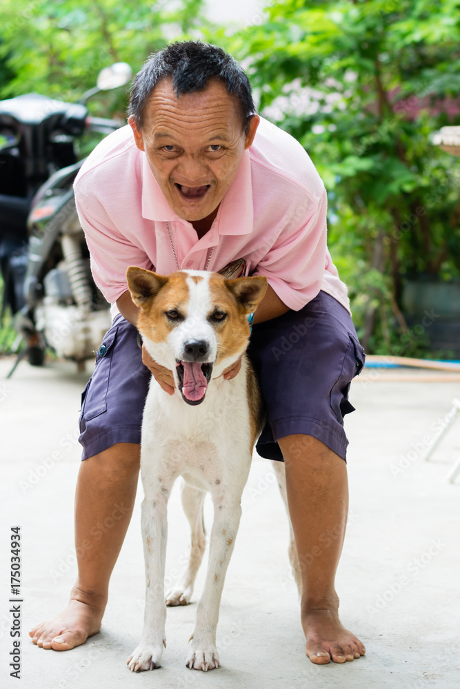 Happy asian man with dog at home Stock Photo | Adobe Stock