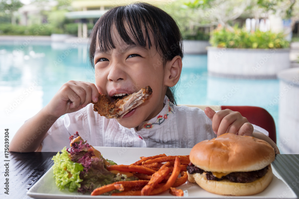 Asian Little Chinese Girl Eating Burger and Fried chicken Stock Photo ...