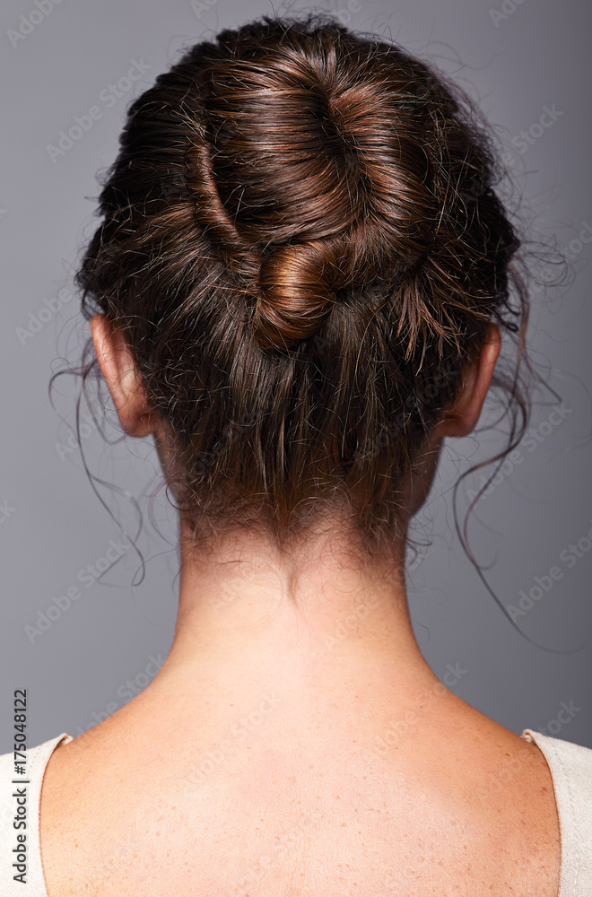Head and shoulders of a young woman from the back side. Female hair ...