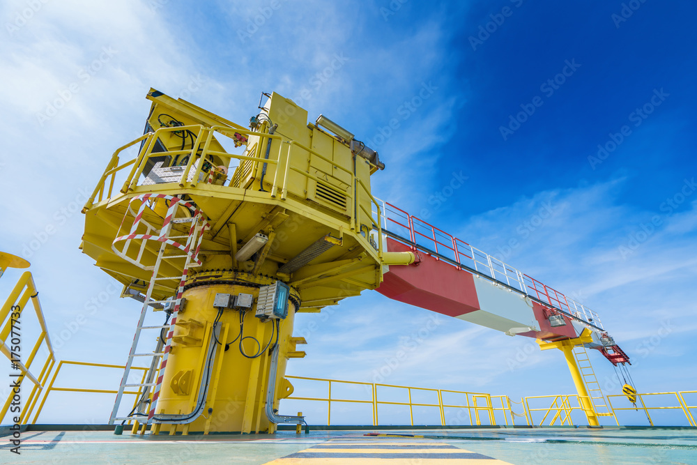 Construction crane on offshore oil and gas wellhead remote platform ...
