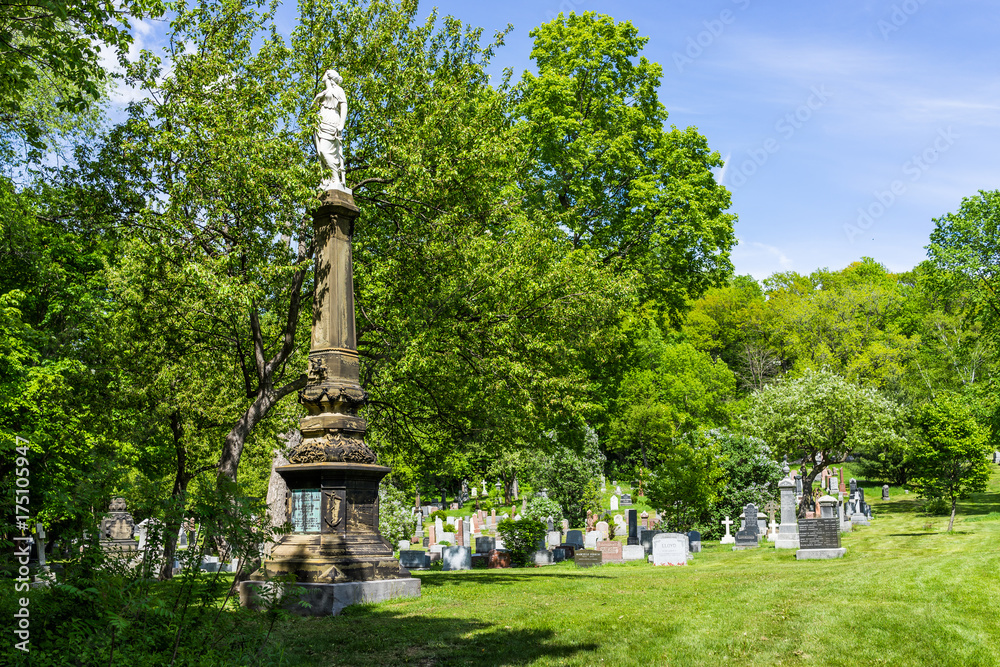Cemetery on Mont Royal with statue during bright sunny day in Quebec ...