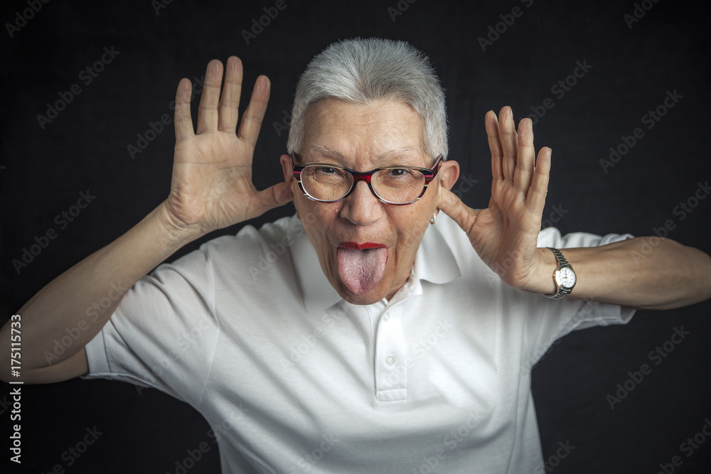 Silly senior woman making fun of you, making silly faces and pulling ...