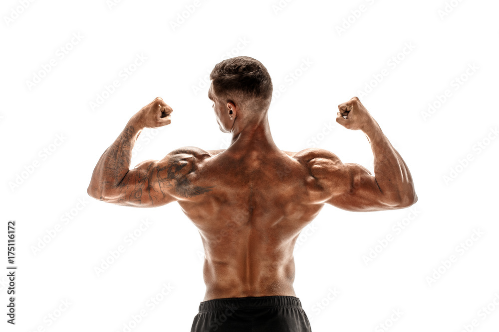 Tattooed Bodybuilder showing his back and biceps muscles isolated on a ...