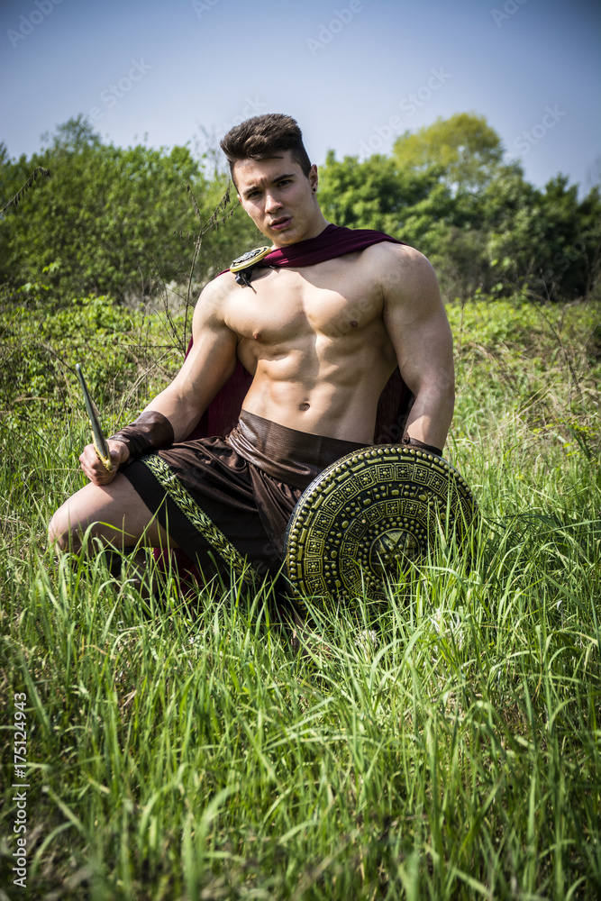 Young handsome muscular man posing in roman or spartan gladiator ...