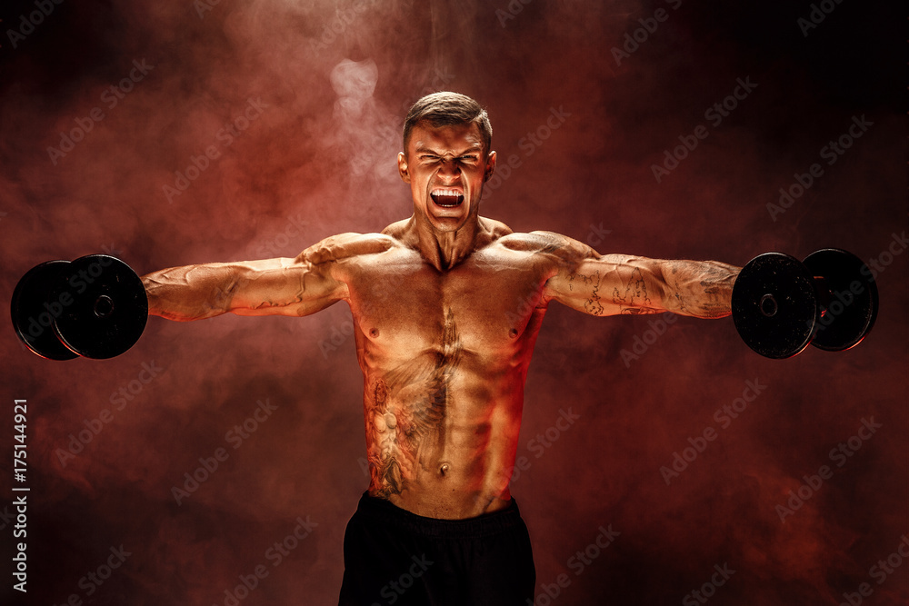 very brawny guy bodybuilder, execute exercise with dumbbells, on ...