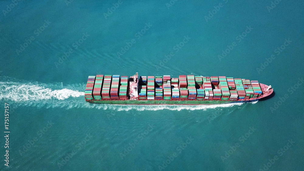 Huge large mega container ship sails on open water fully loaded with ...