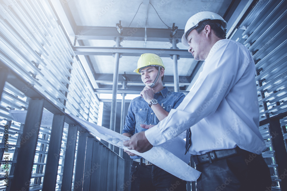 engineer and construction team working on checking progress of ...
