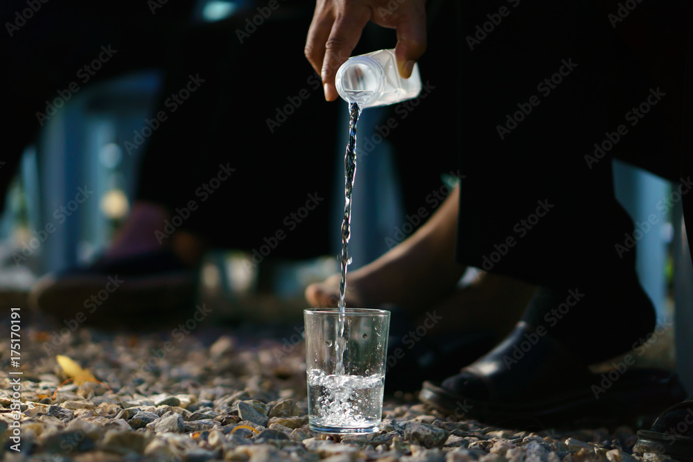 Hand pouring water as a good deed and share the wealth to Buddhism or a ...