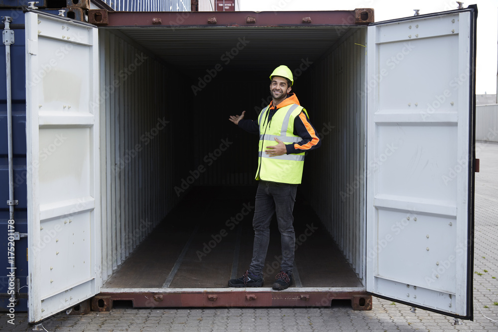 Portrait of docker showing cargo container, smiling Stock Photo | Adobe ...