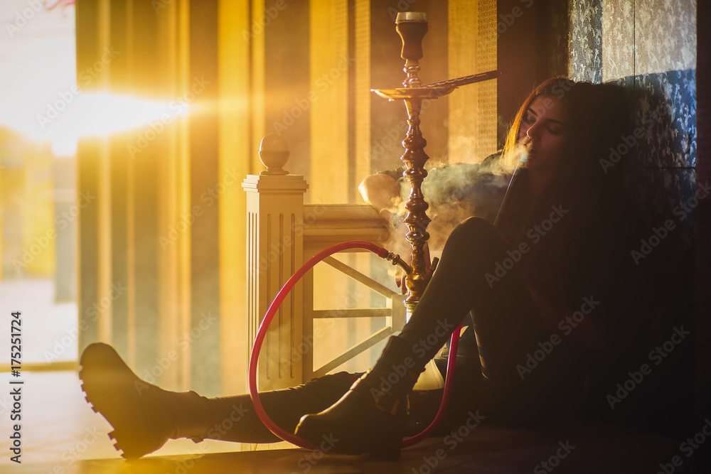 Concept: recreation, millennial, nightlife. Beautiful young woman smoke ...