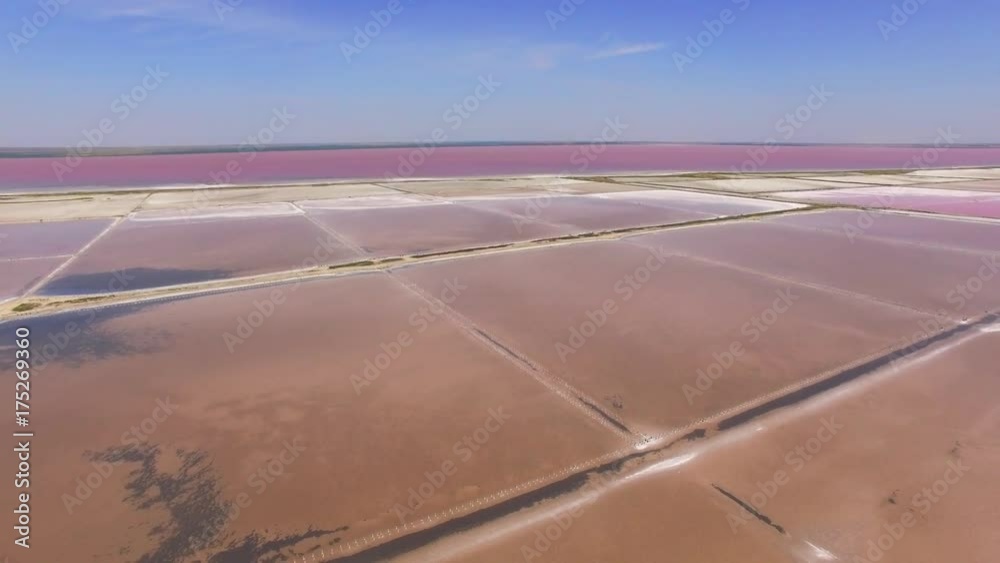 Salt production in salt ponds / Salt evaporation ponds at red salty ...
