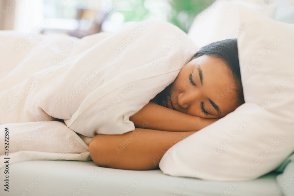 Side view of a young asian woman sleeping in white bed. Stock Photo ...