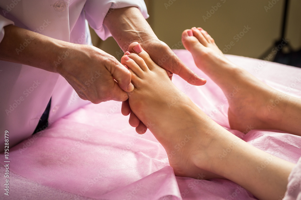 Foot massage in spa salon, closeup,Young woman having feet massage in ...