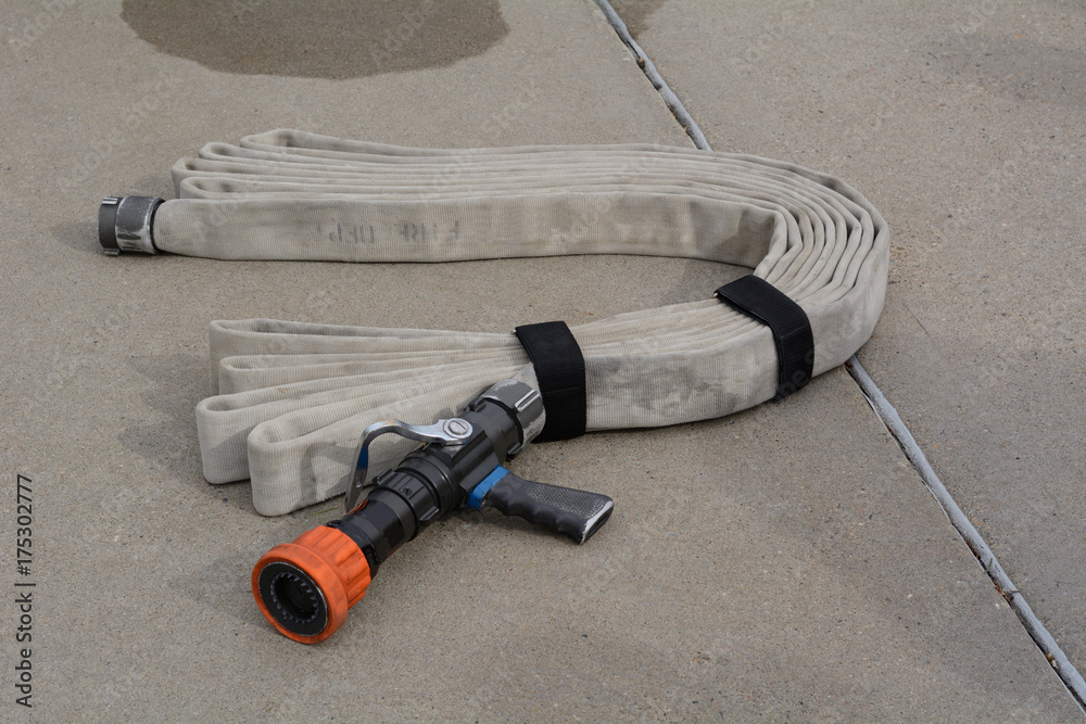 Inspected fire hose arranged and tied in preparation of placement in ...