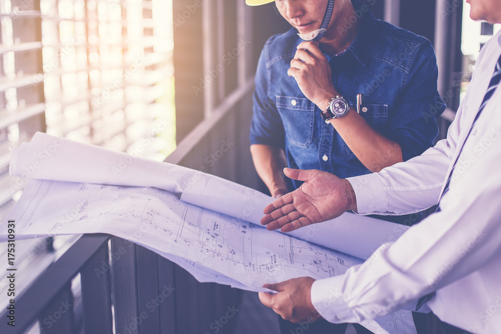 contractor and engineer with blueprints discuss at a modern ...