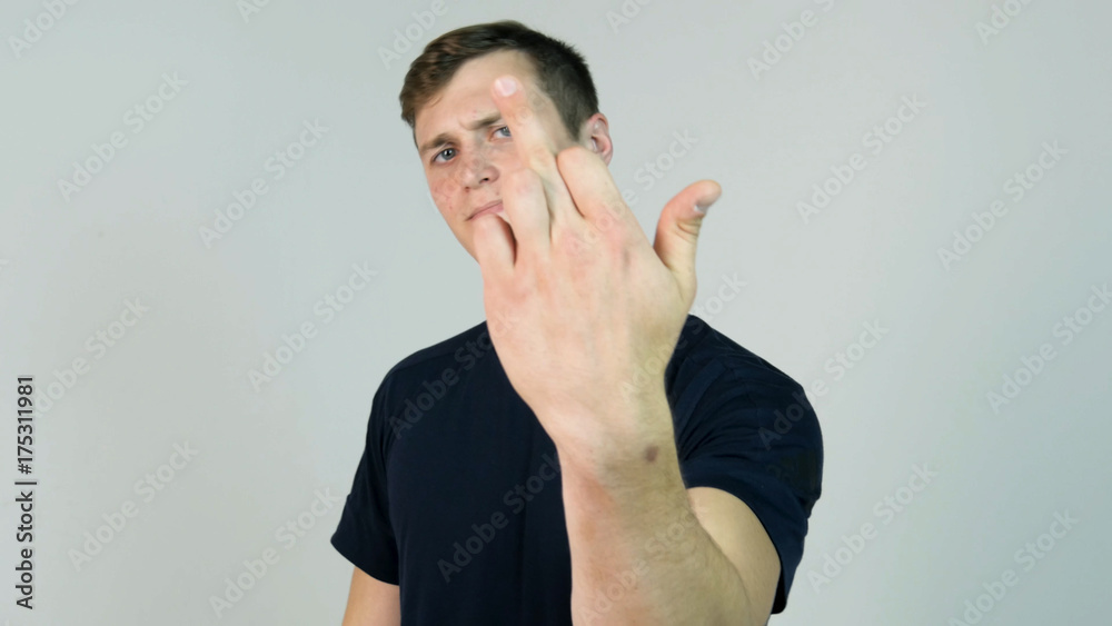 Young Man Showing Middle Finger Isolated on White. Young angry man with ...