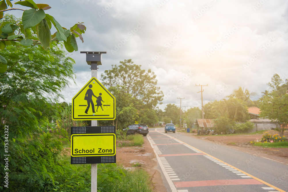 Yellow sign school zone symbol in the countryside . Stock Photo | Adobe ...