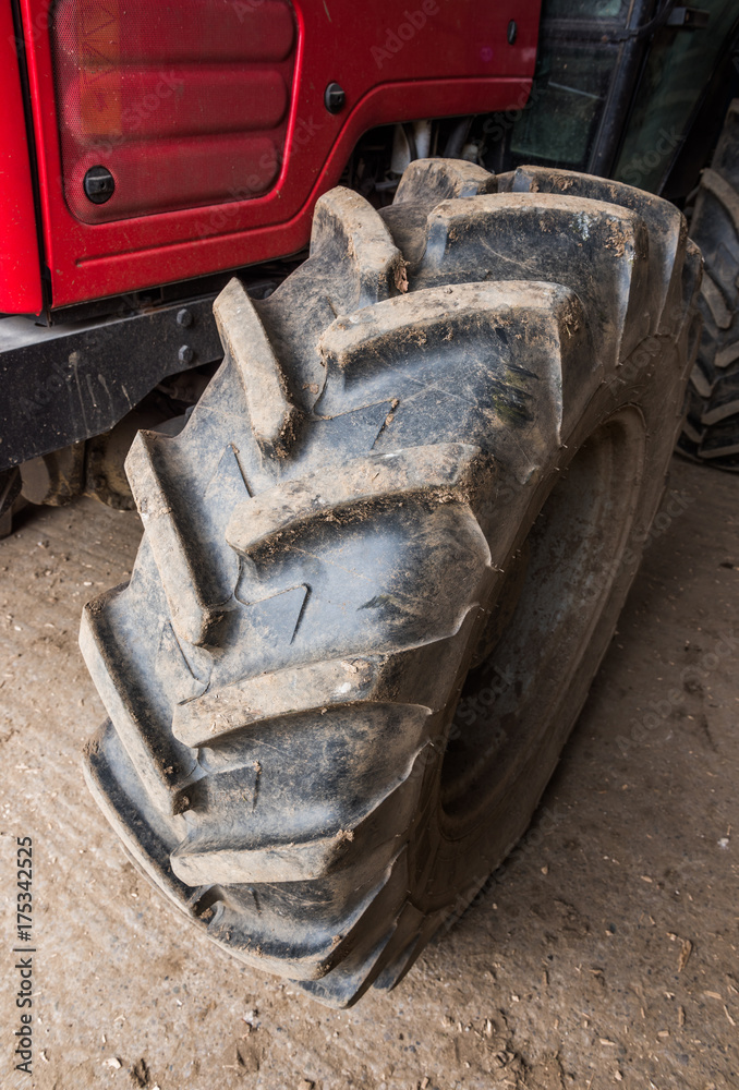 A big used dirty farm tractor tread, with big strong gripping treads ...