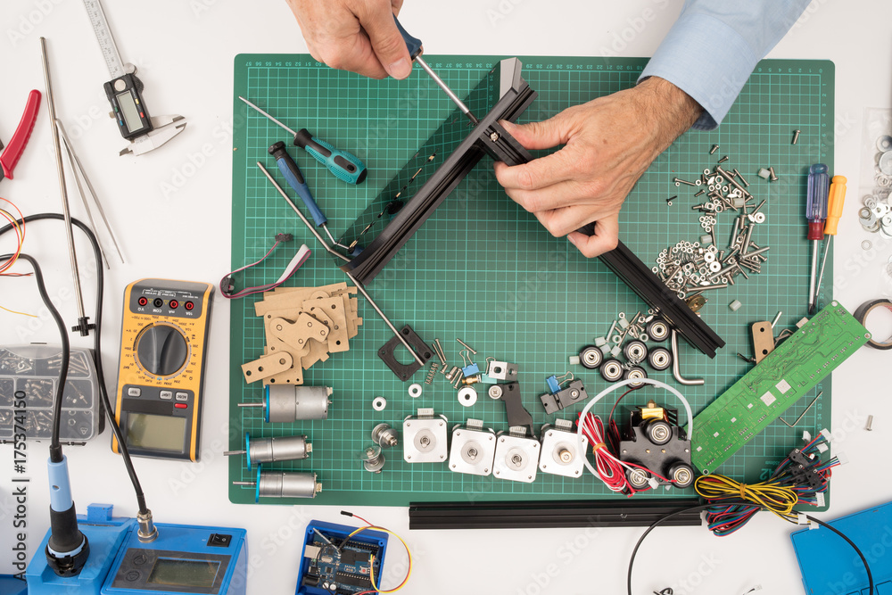 manual assembly of electronic mechanical device from a set of spare ...