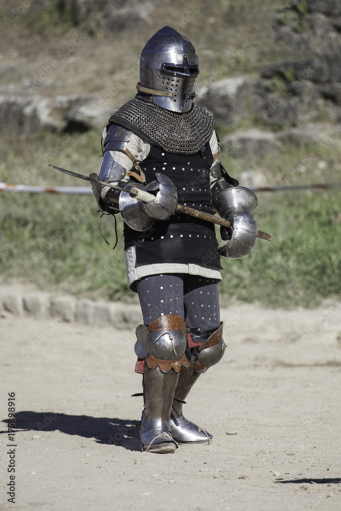 Men in a medieval battle. They are protected by armors from the 14th ...