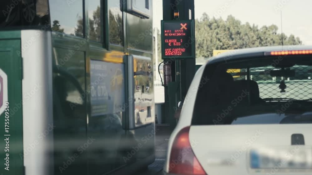 A man pays money by card in terminal to a cashier for a toll road Toll ...